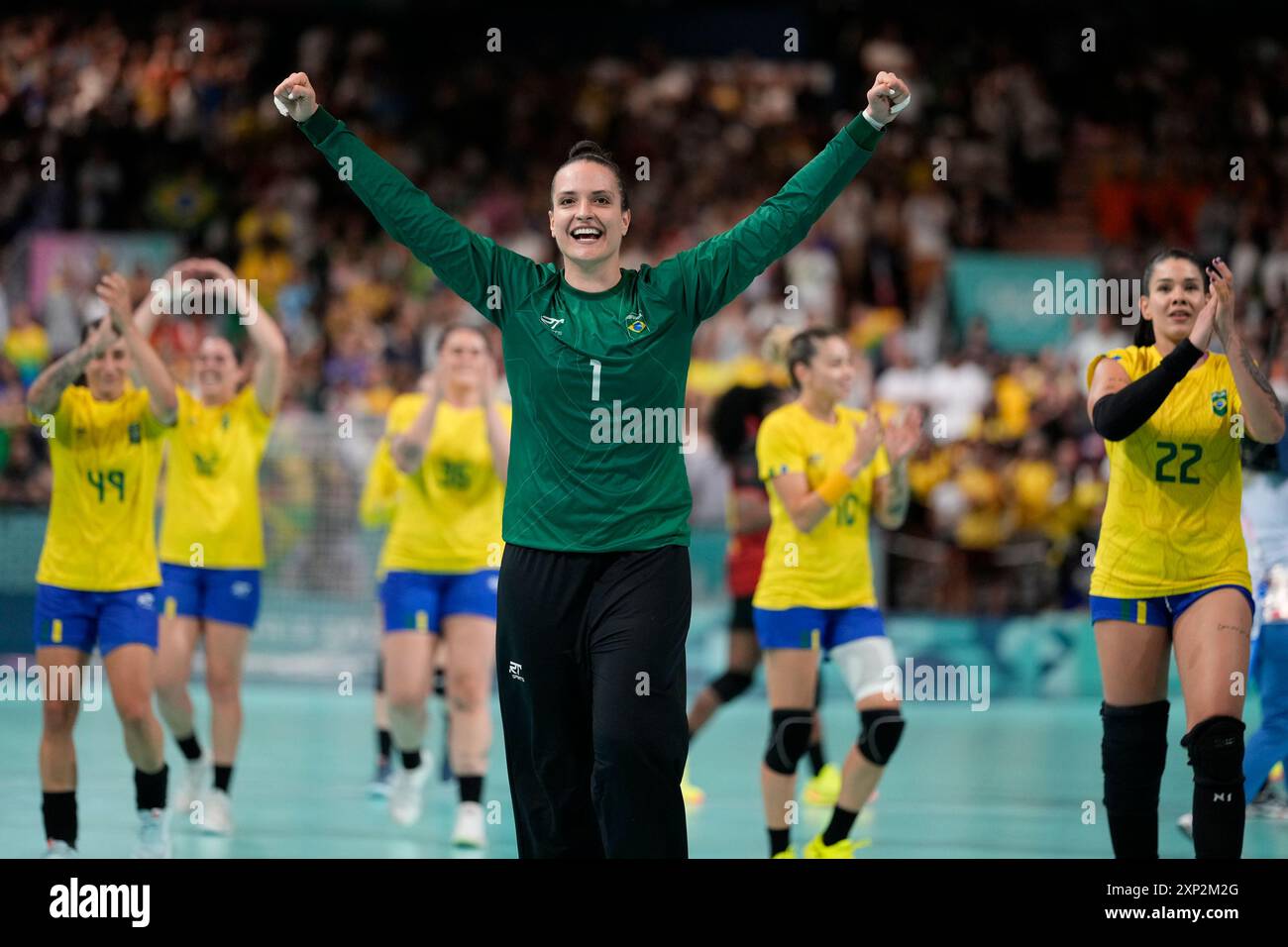 Members of the Brazil team celebrate after winning against Angola ...