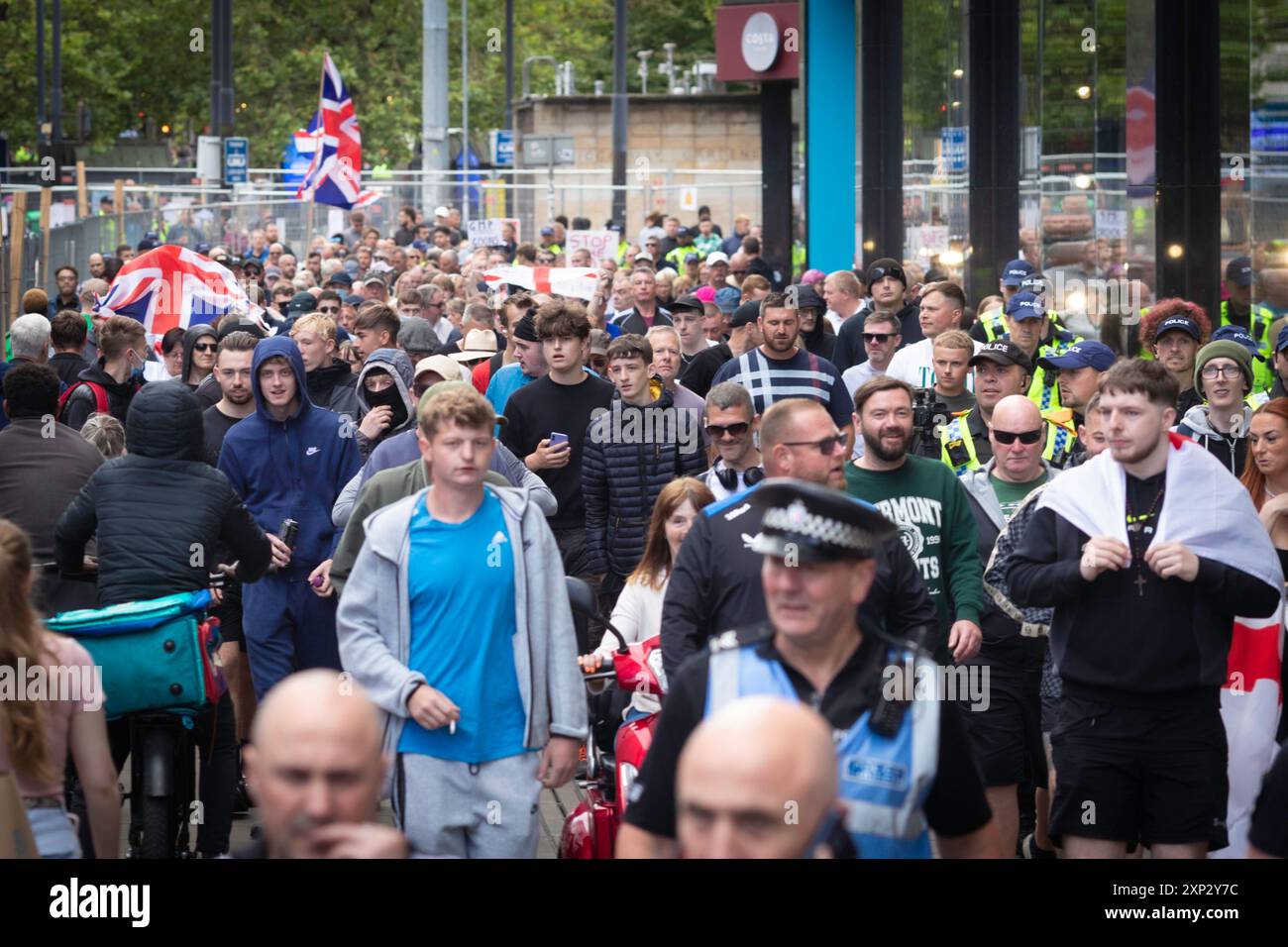 Manchester, UK. 03rd Aug, 2024. Anti-immigration supporters march ...