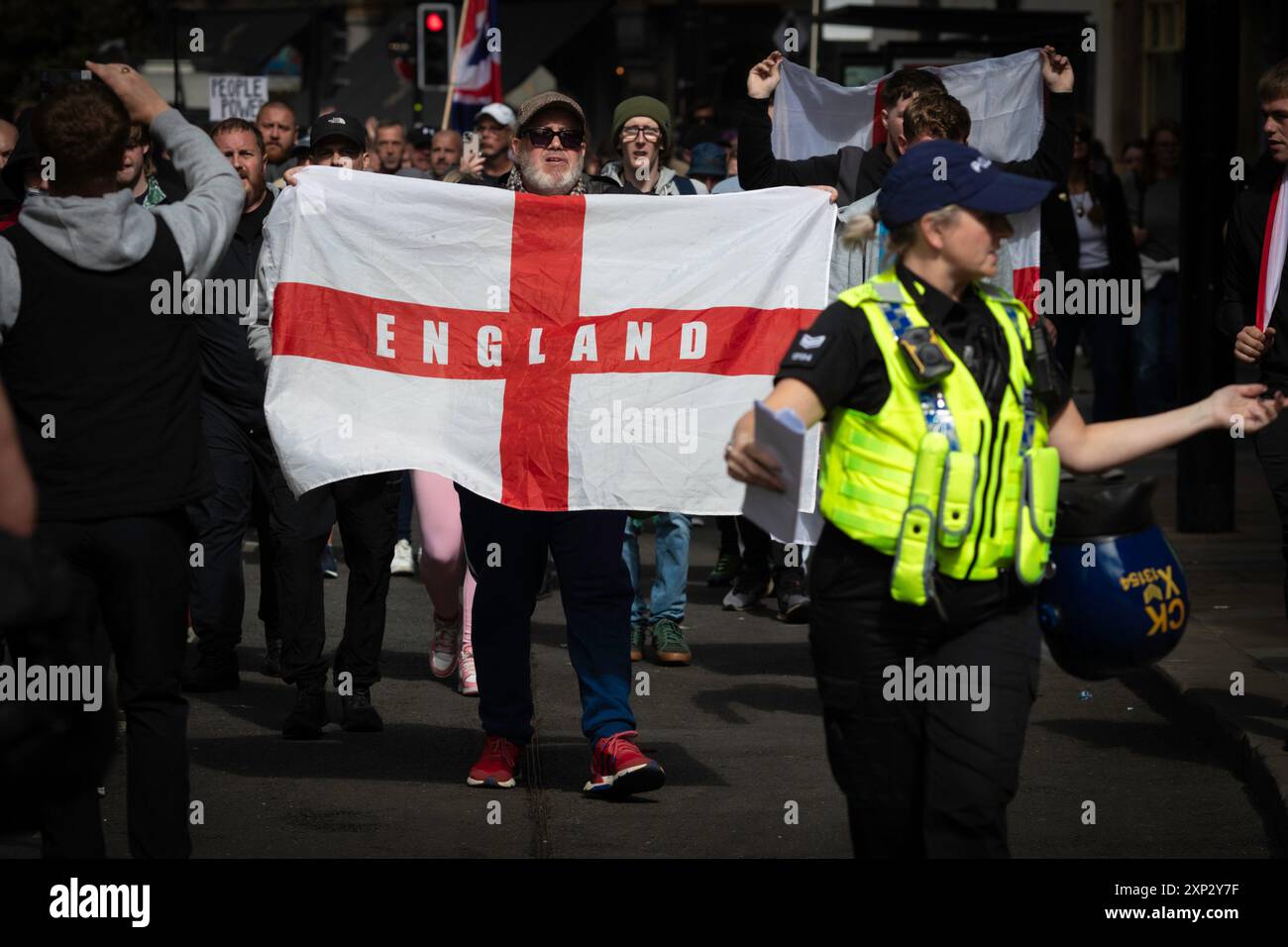 Manchester, UK. 03rd Aug, 2024. A man with a St Georges flag attends a ...