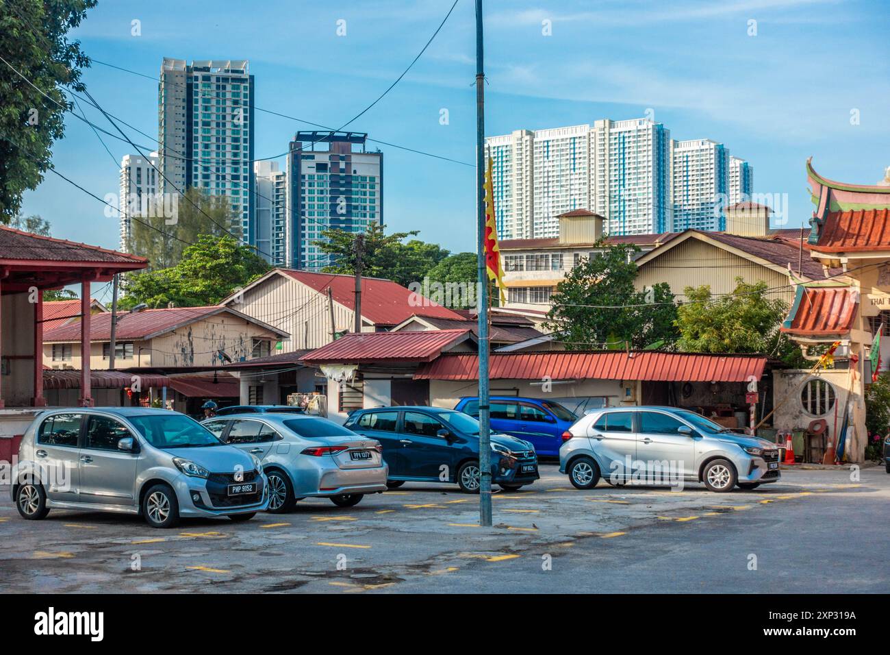 Car park for The Pak Koong Temple with modern tower blocks in the ...