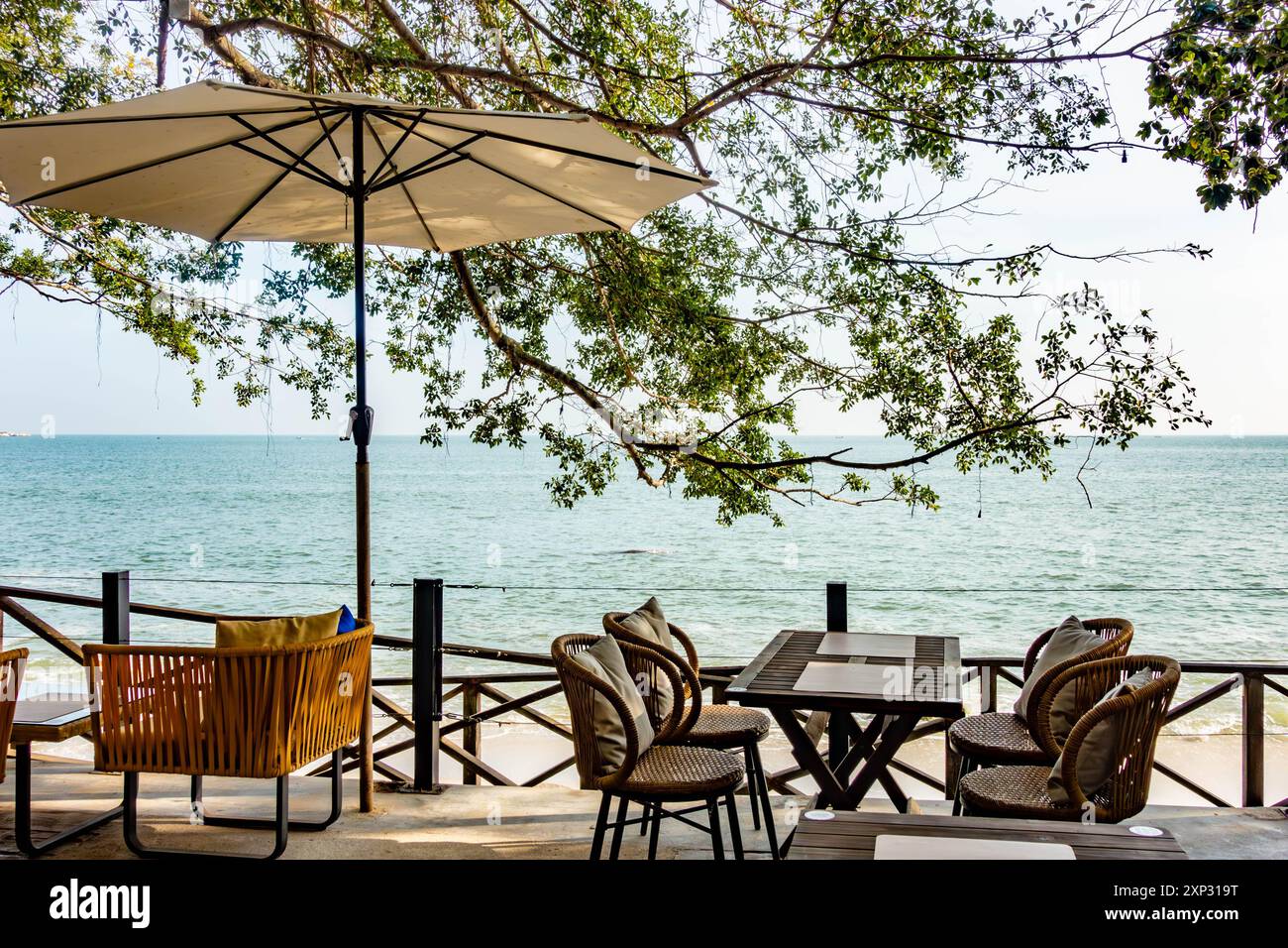 Tables, chairs and a parasol at a restaurant with views over Tanjing ...
