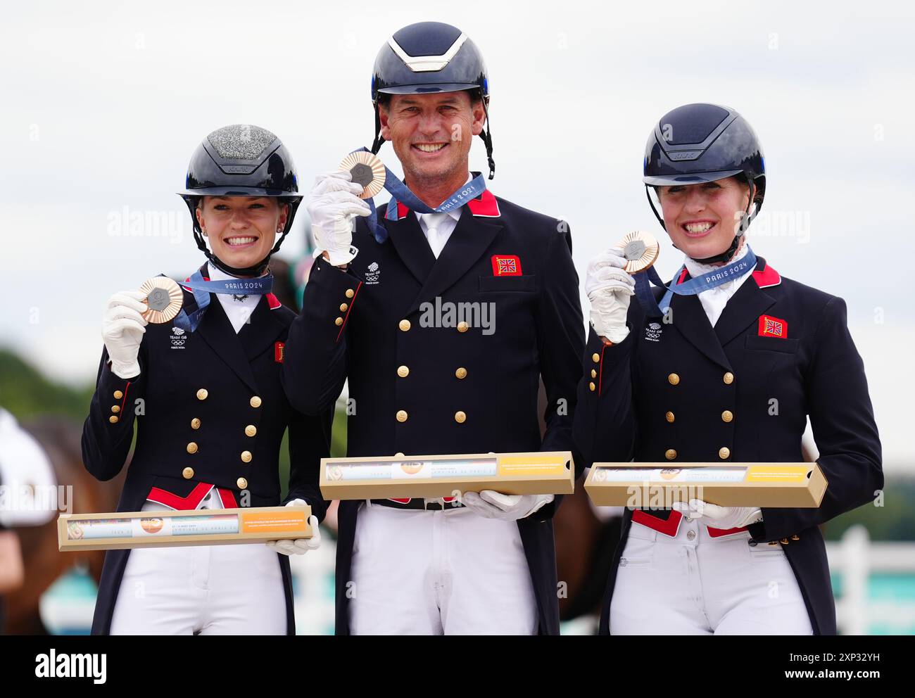 Great Britain’s Charlotte Fry, Carl Hester and Becky Moody after winning a bronze medal in the ...