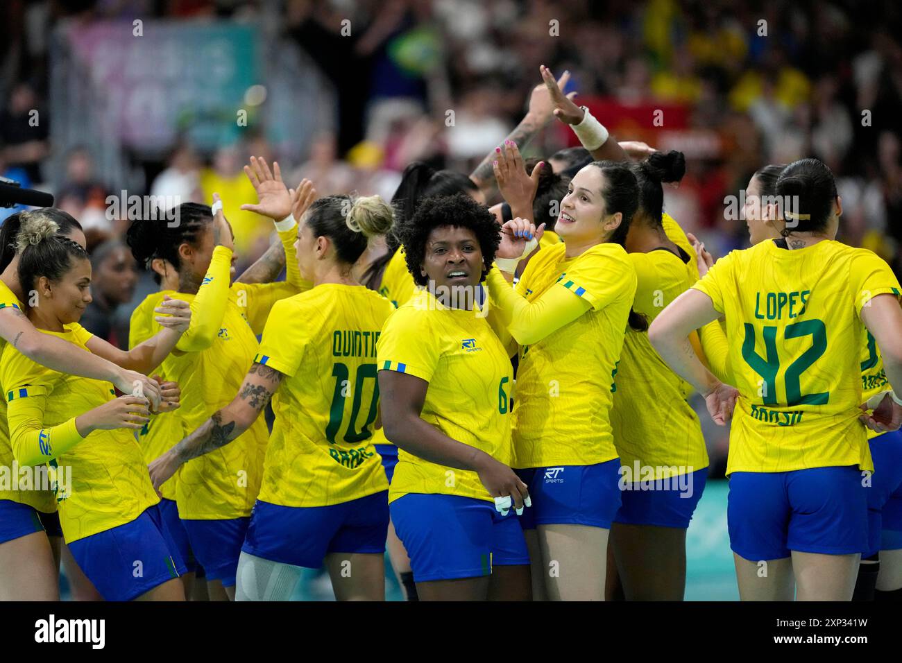 Members of the Brazil team celebrate after winning against Angola ...