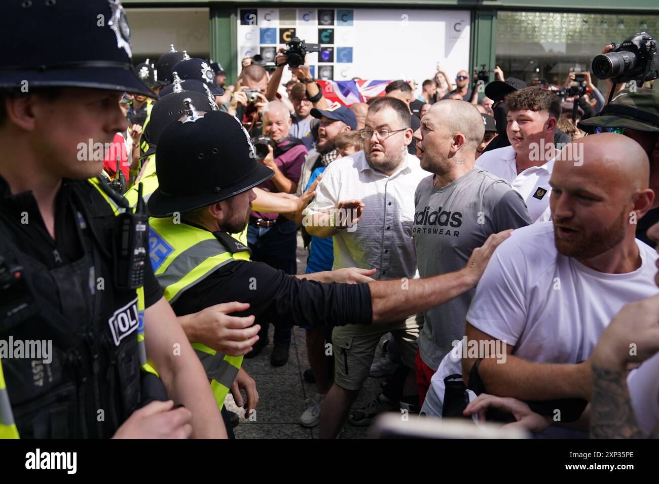 Police officers with people as they protest in Nottingham Market Square ...
