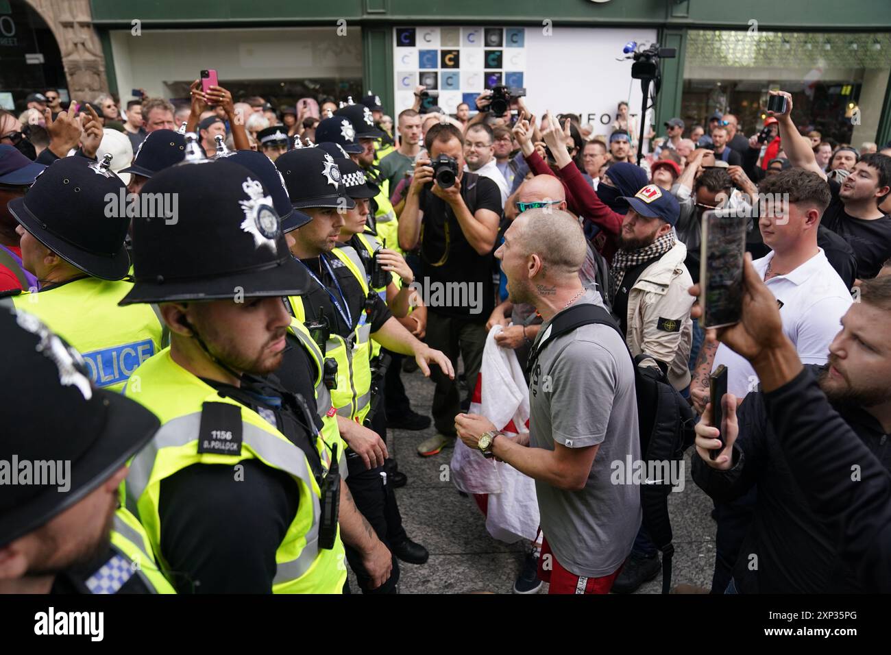 Police officers with people as they protest in Nottingham Market Square ...