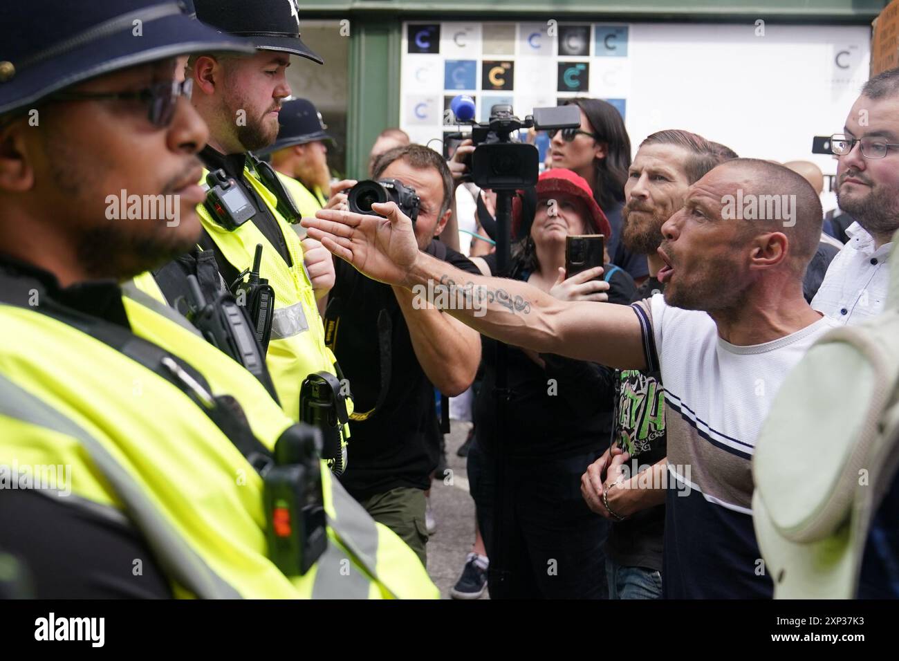 Police officers with people as they protest in Nottingham Market Square ...