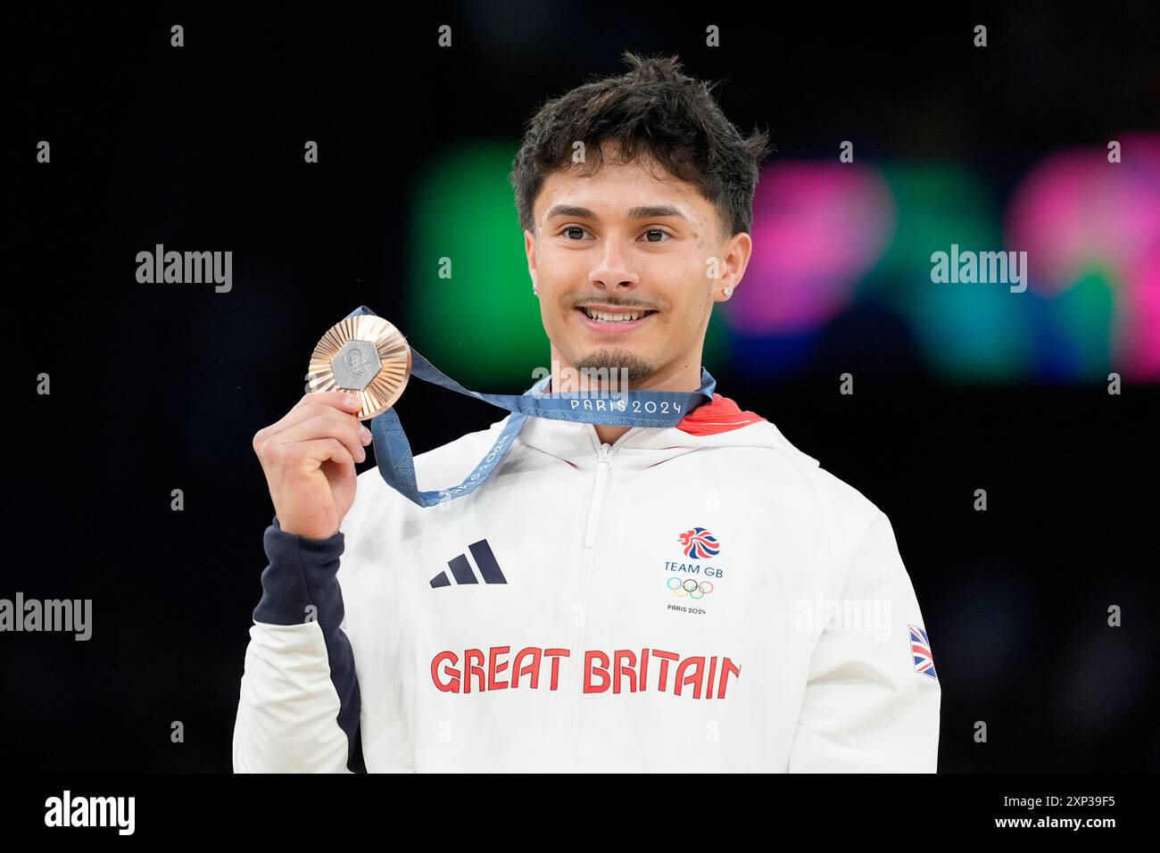 Jake Jarman, of Britain, celebrates after winning the bronze medal ...