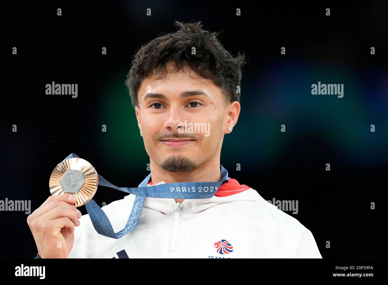 Jake Jarman, of Britain, celebrates after winning the bronze medal ...