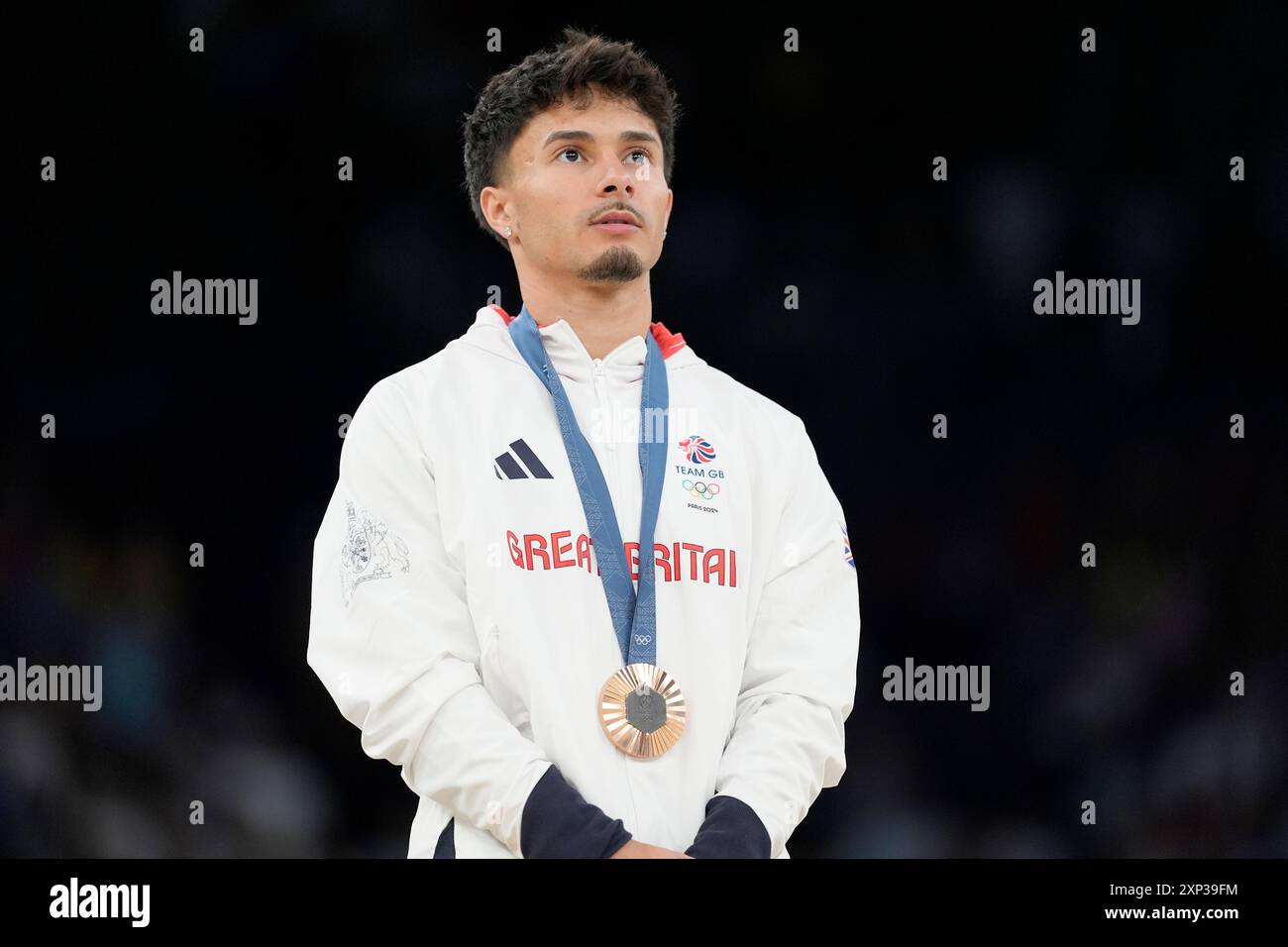 Jake Jarman, of Britain, stands on the podium after winning the bronze ...