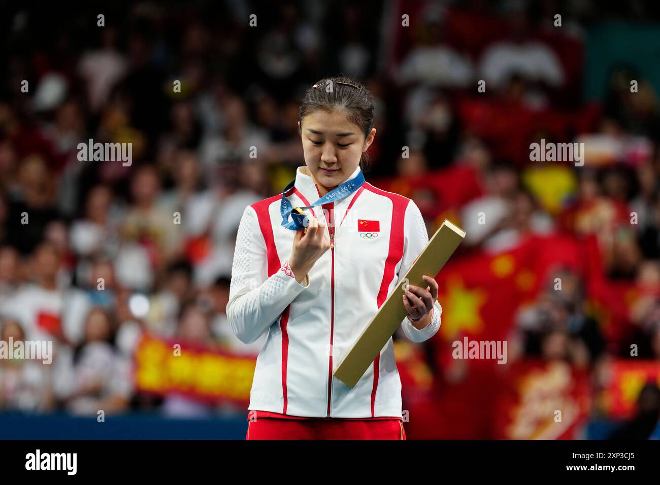 China's Chen Meng looks her gold medal after defeating China's Sun ...