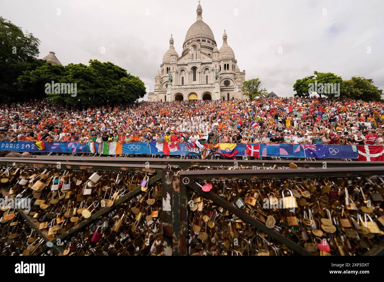 Ali Labib, of Iran, rides past the Sacre Coeur basilica, during the men ...