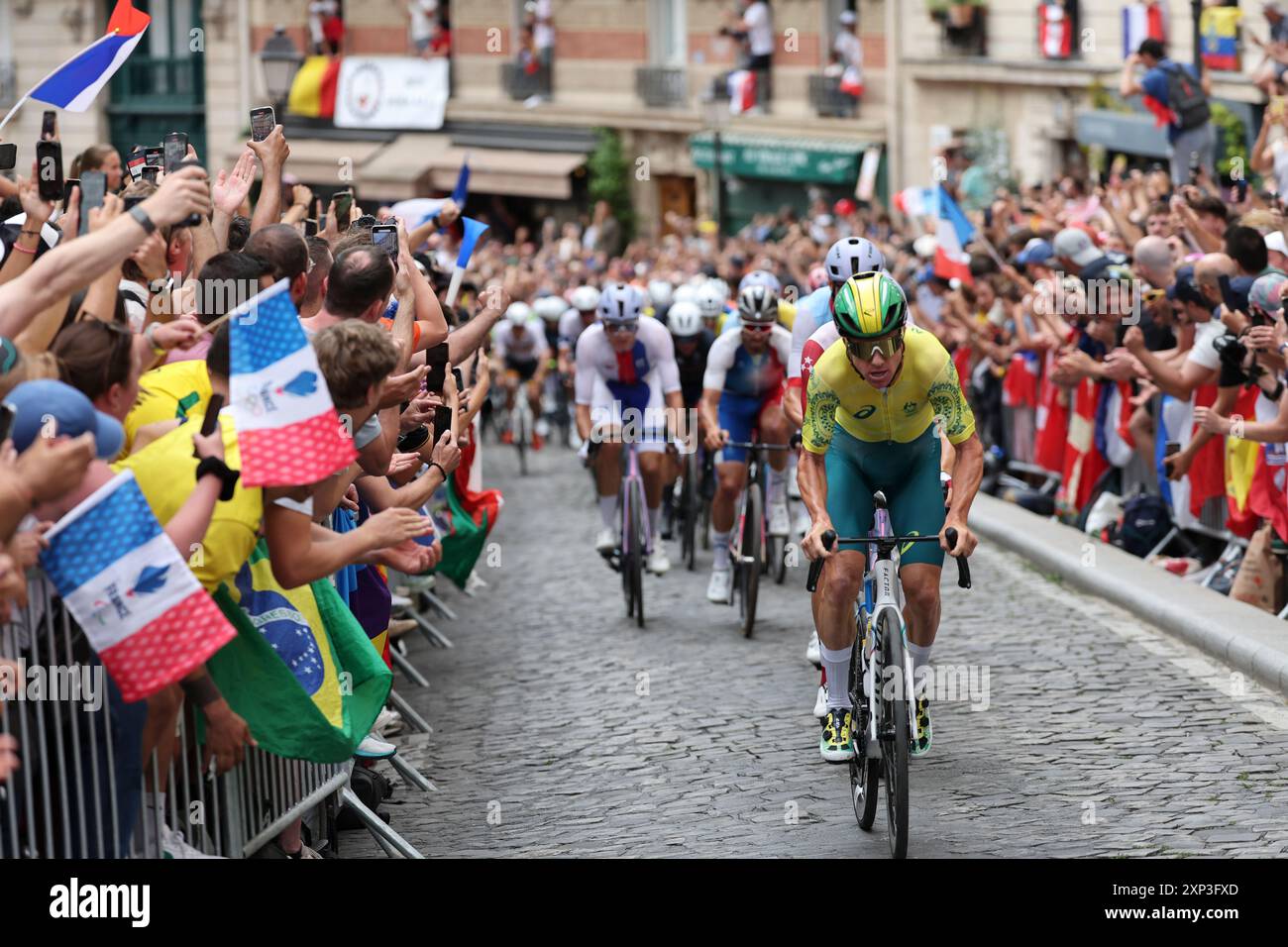 Riders are cheered by spectators during the men's road cycling event ...