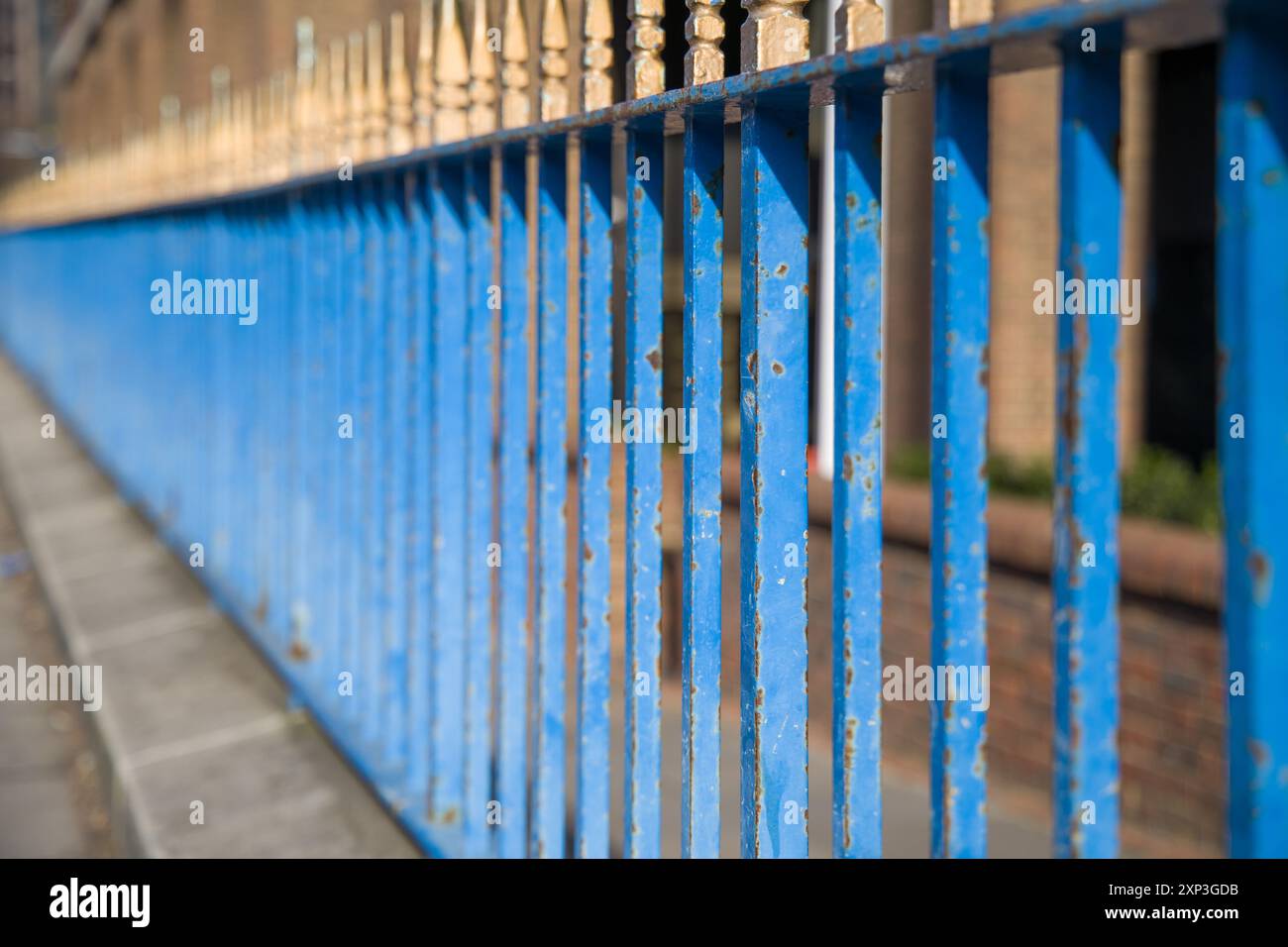 Blue metal reilings between path and a road Stock Photo - Alamy
