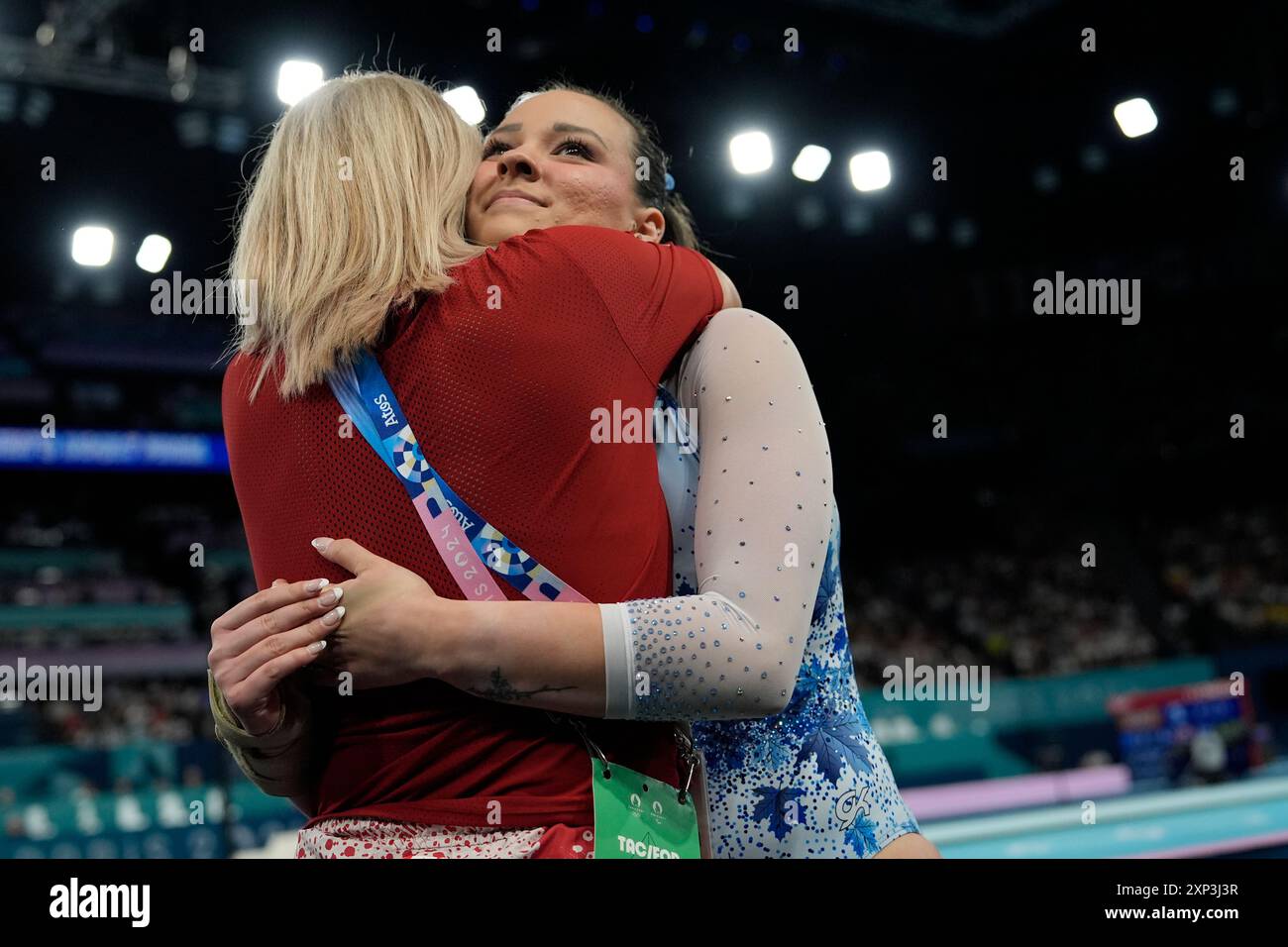 Shallon Olsen, right, of Canada, gets a hug during the women's artistic ...
