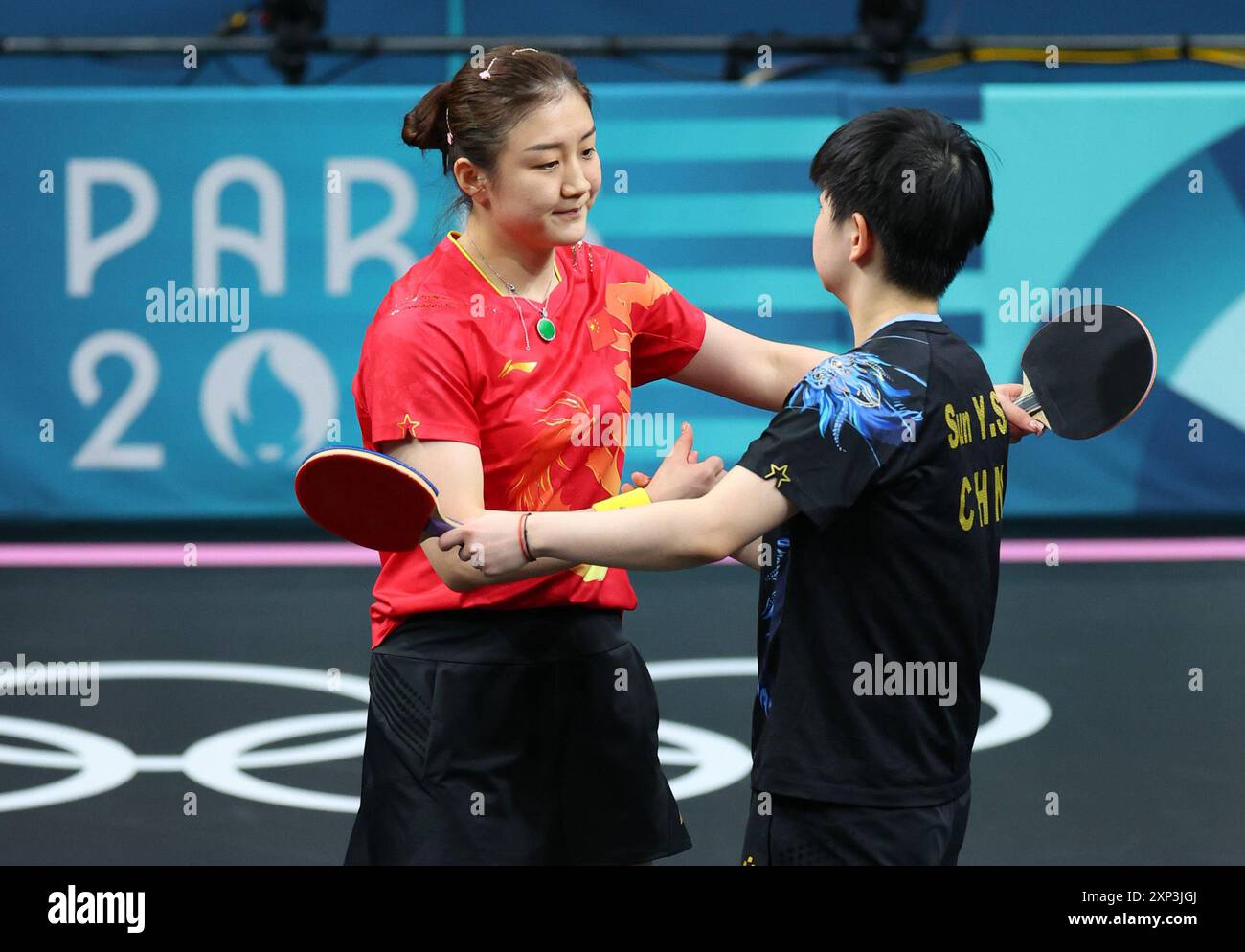 Paris, France. 3rd Aug, 2024. China's Chen Meng (L) hugs Sun Yingsha after the women's singles ...