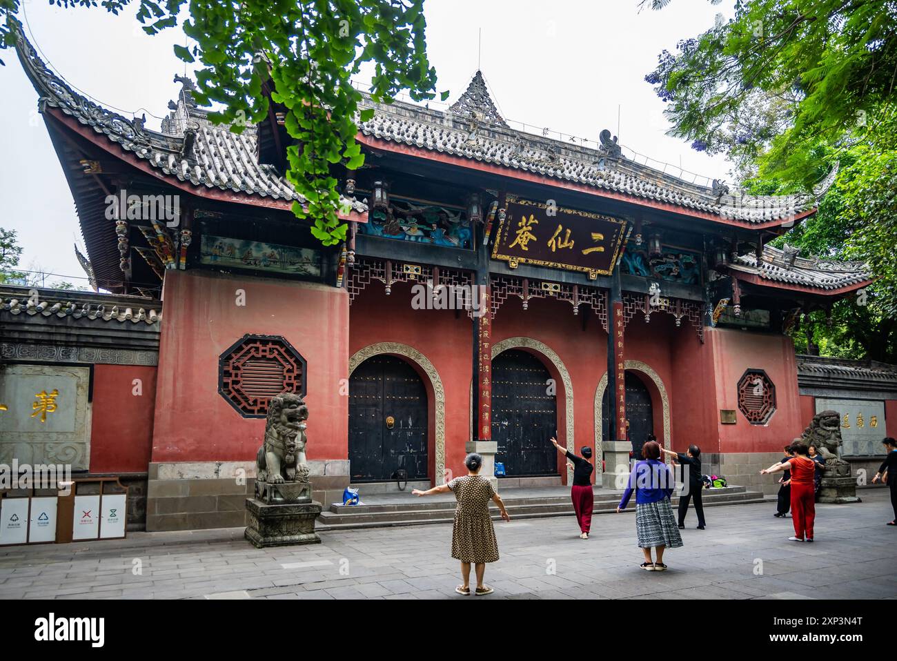 Women exercise in front of a temple in the morning. Chengdu, Sichuan ...