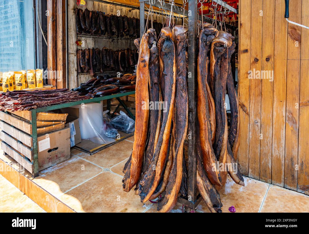 Smoked bacon hanging in front of a store. Sichuan, China Stock Photo ...