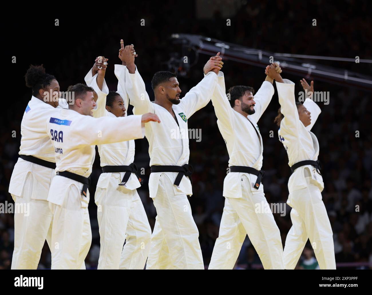 A Brazil team celebrates after winning in the judo mixed team ...
