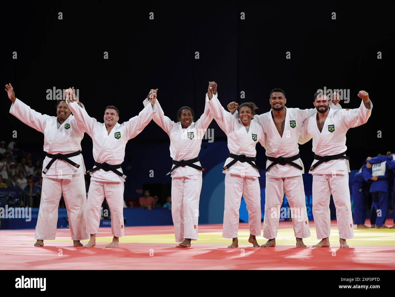 A Brazil team celebrates after winning in the judo mixed team ...