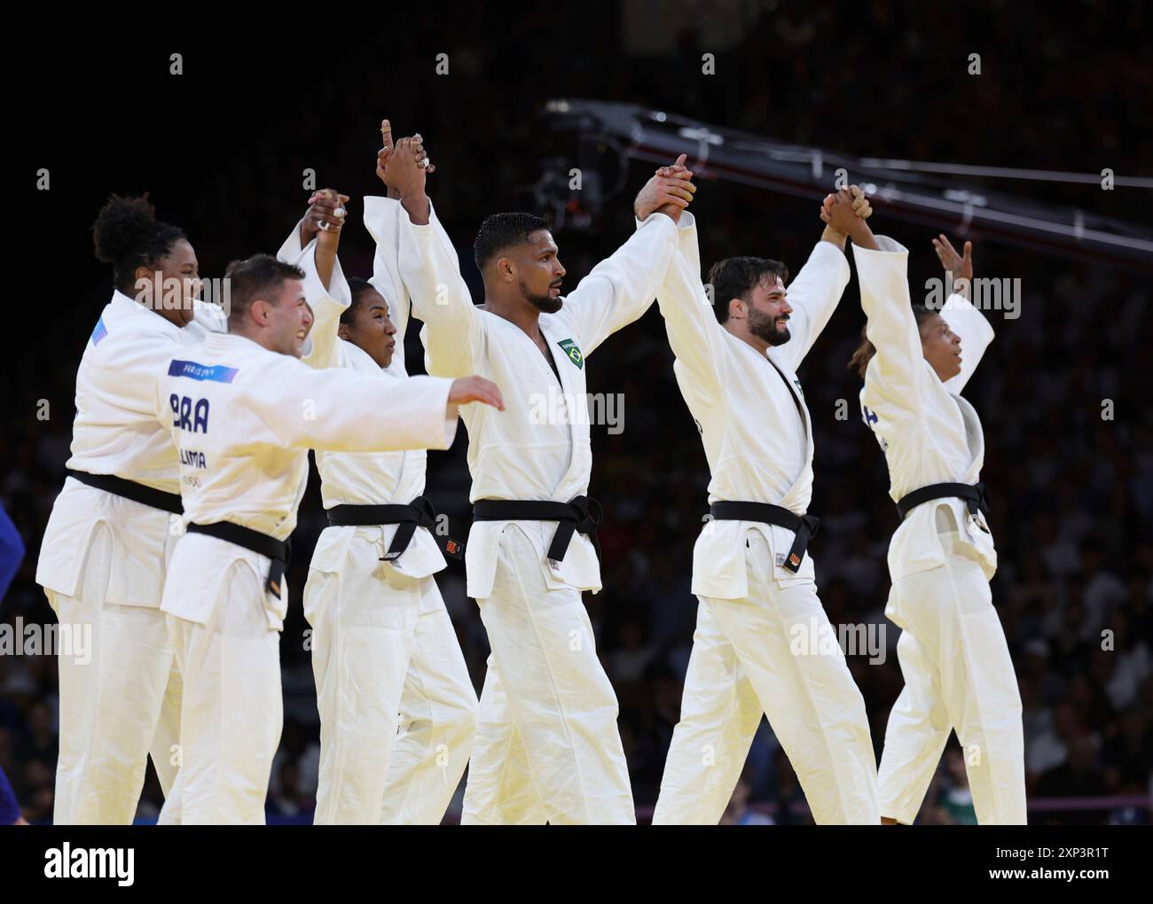 A Brazil team celebrates after winning in the judo mixed team ...