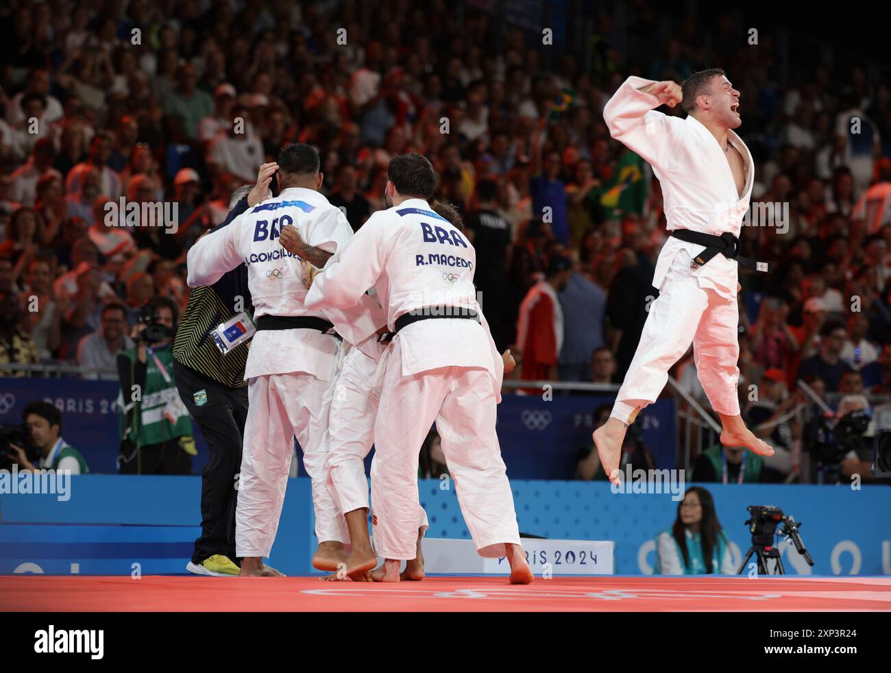 A Brazil team celebrates after winning in the judo mixed team ...
