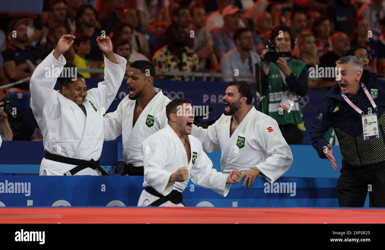 A Brazil team celebrates after winning in the judo mixed team ...