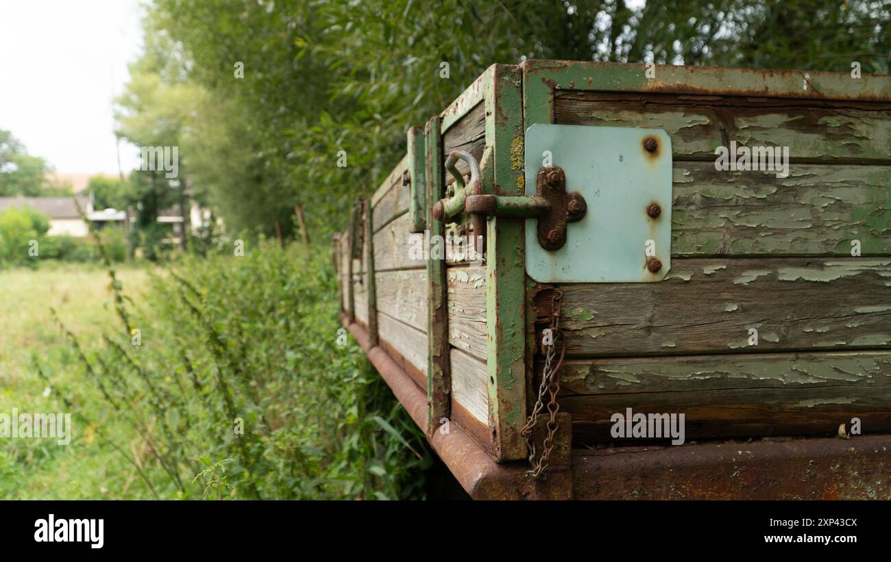 Old farm trailer in the bushes. Wooden sides. Museum object. Abandoned ...
