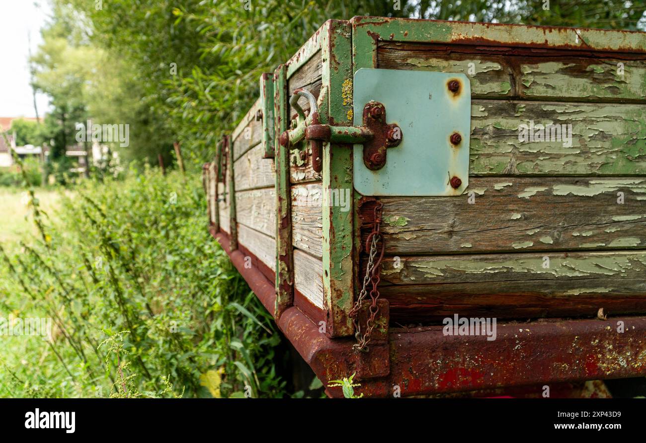 Old farm trailer in the bushes. Wooden sides. Museum object. Abandoned ...