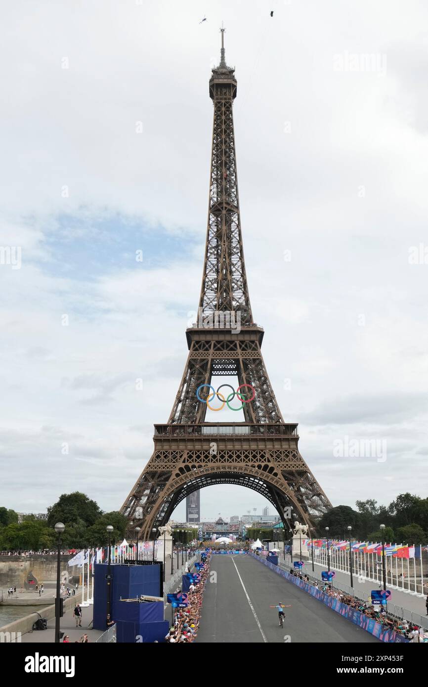 Remco Evenepoel, of Belgium, celebrates past the Eiffel Tower winning ...
