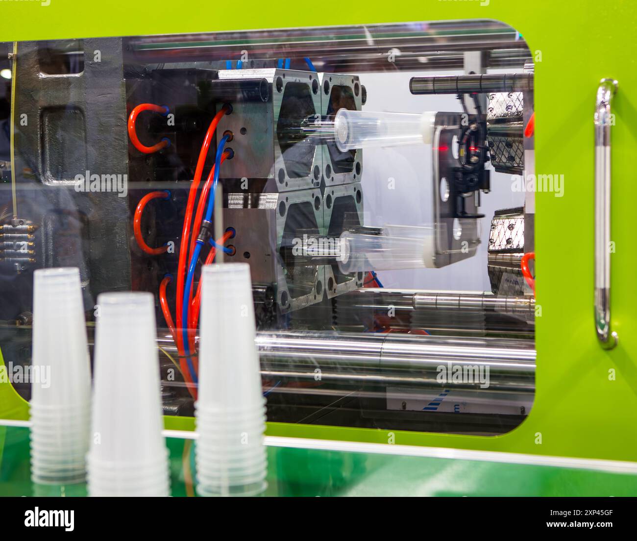 Plastic cups from plastic injection molding press machine. Industrial ...