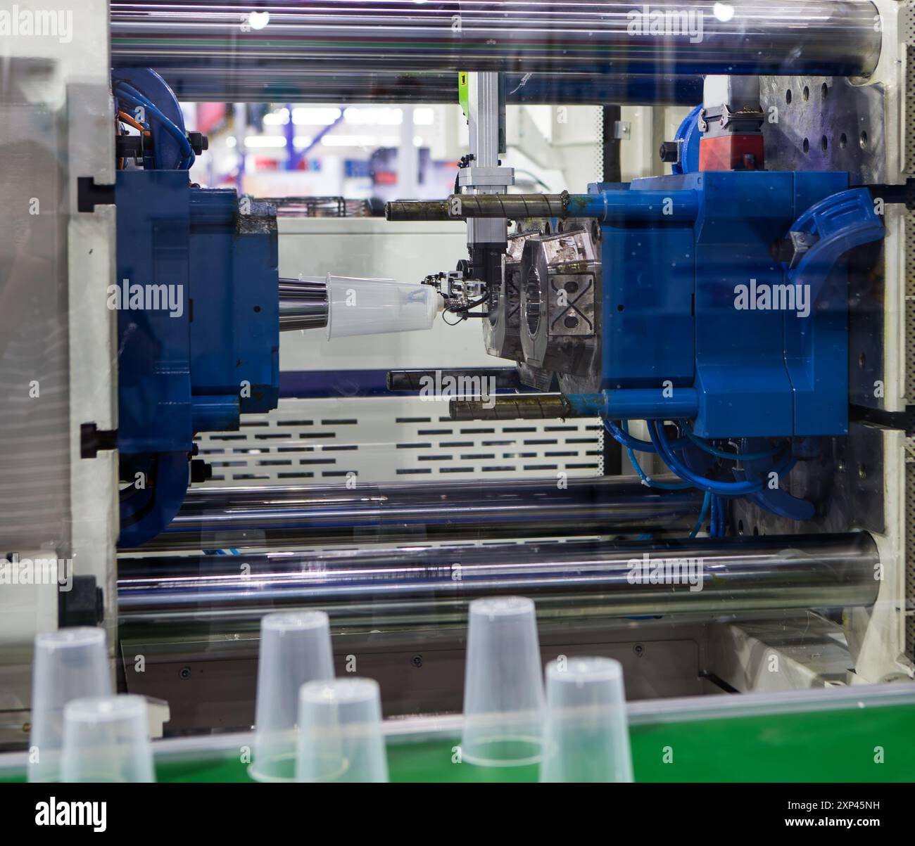 Plastic cups from plastic injection molding press machine. Industrial ...