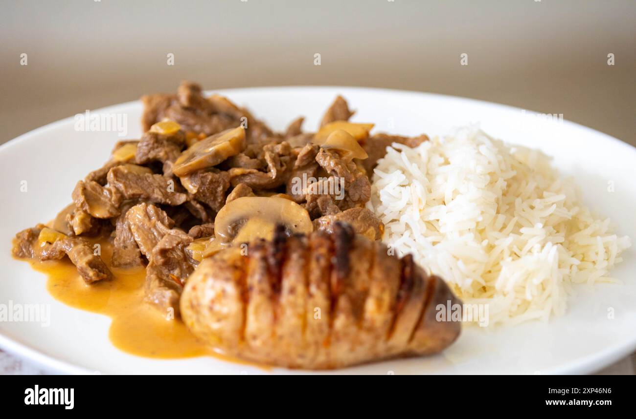Traditional filet mignon stroganoff with rustic potatoes Stock Photo ...