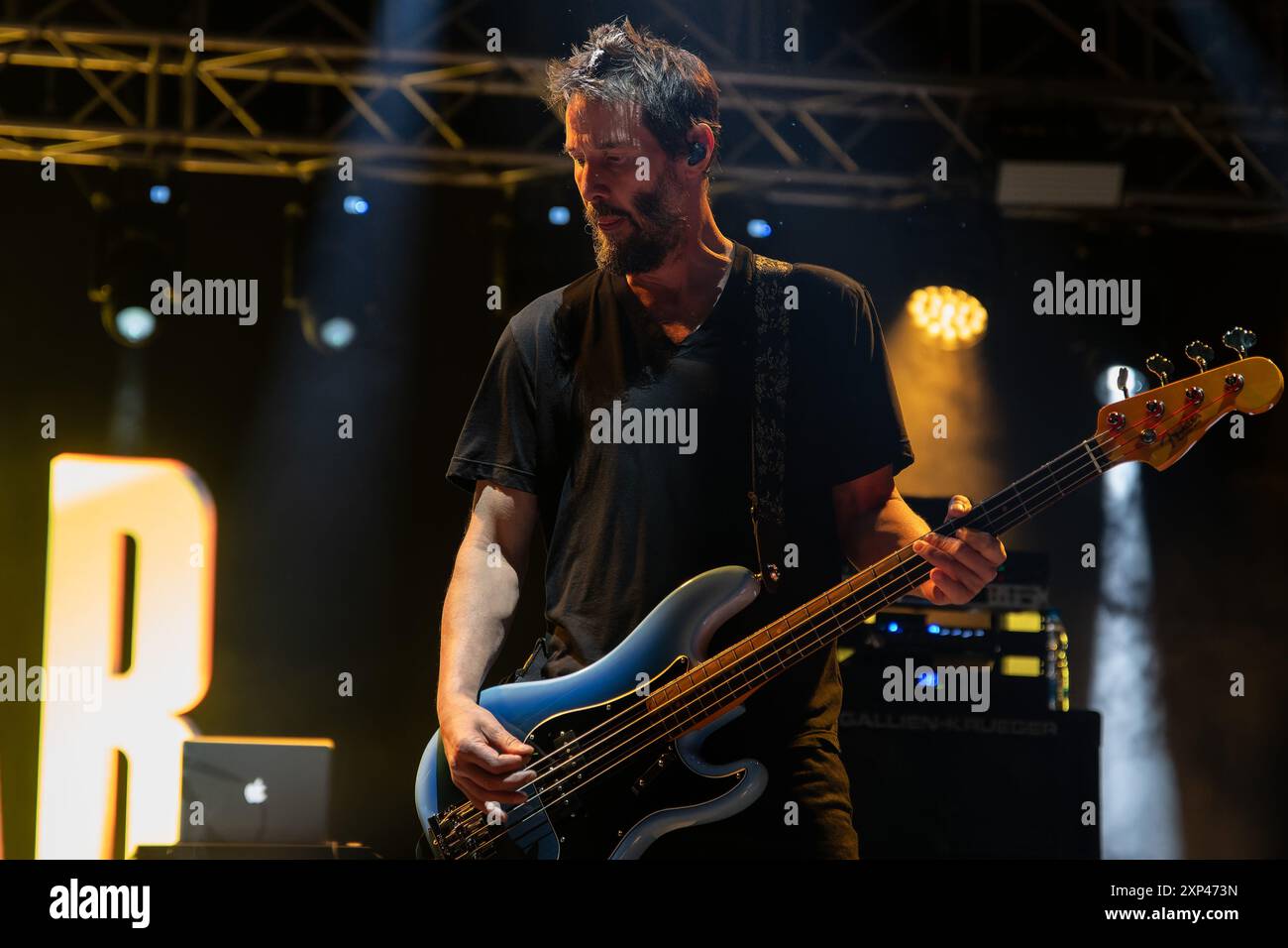 Headshot of actor Keanu Reeves playing bass guitar with his band ...