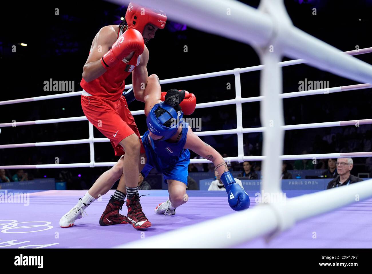 Hungary's Anna Hamori falls to the mat against Algeria's Imane Khelif ...