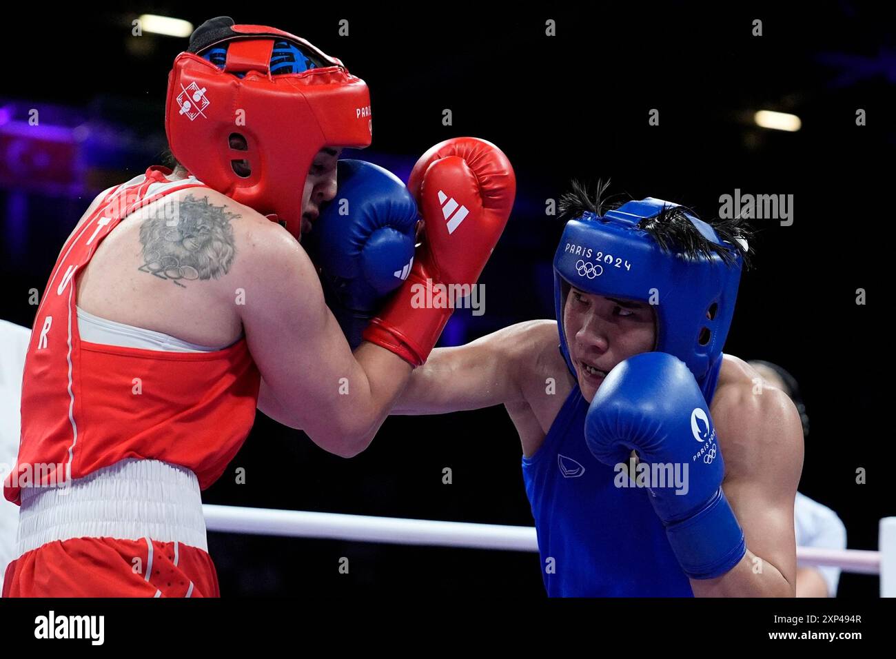 Turkey's Busenaz Surmeneli, left, fights Thailand's Janjaem ...