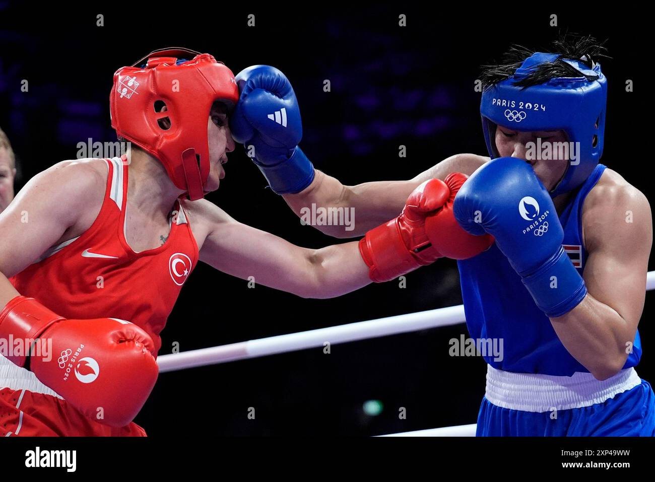 Turkey's Busenaz Surmeneli, left, fights Thailand's Janjaem ...