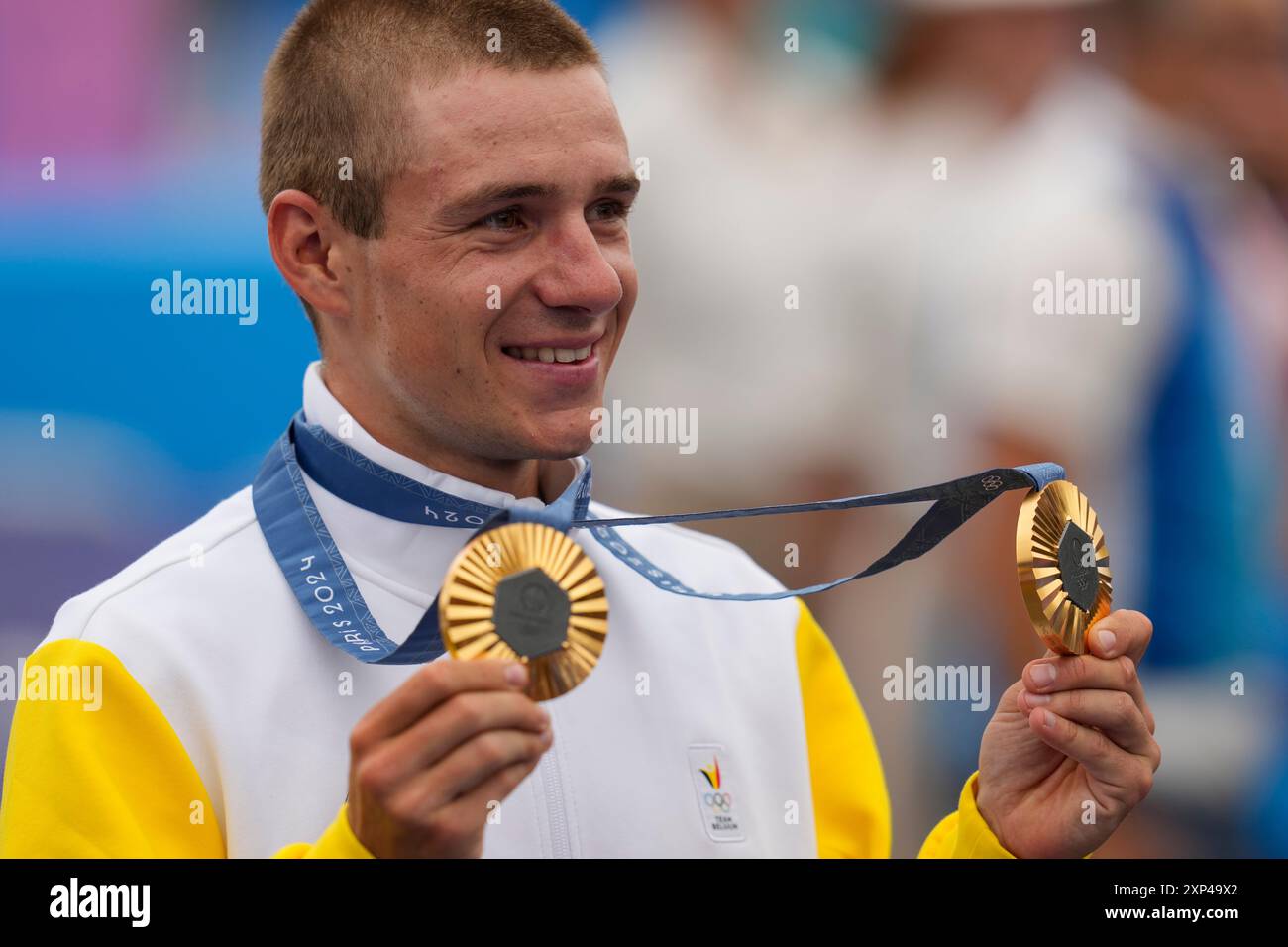 Remco Evenepoel, of Belgium, shows his gold medals of the men's time ...