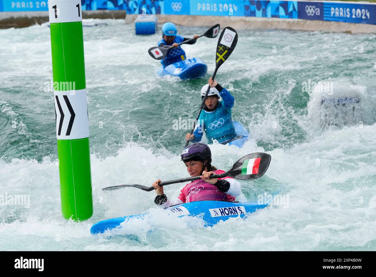 Stefanie Horn of Italy competes in the women's kayak cross repechage ...