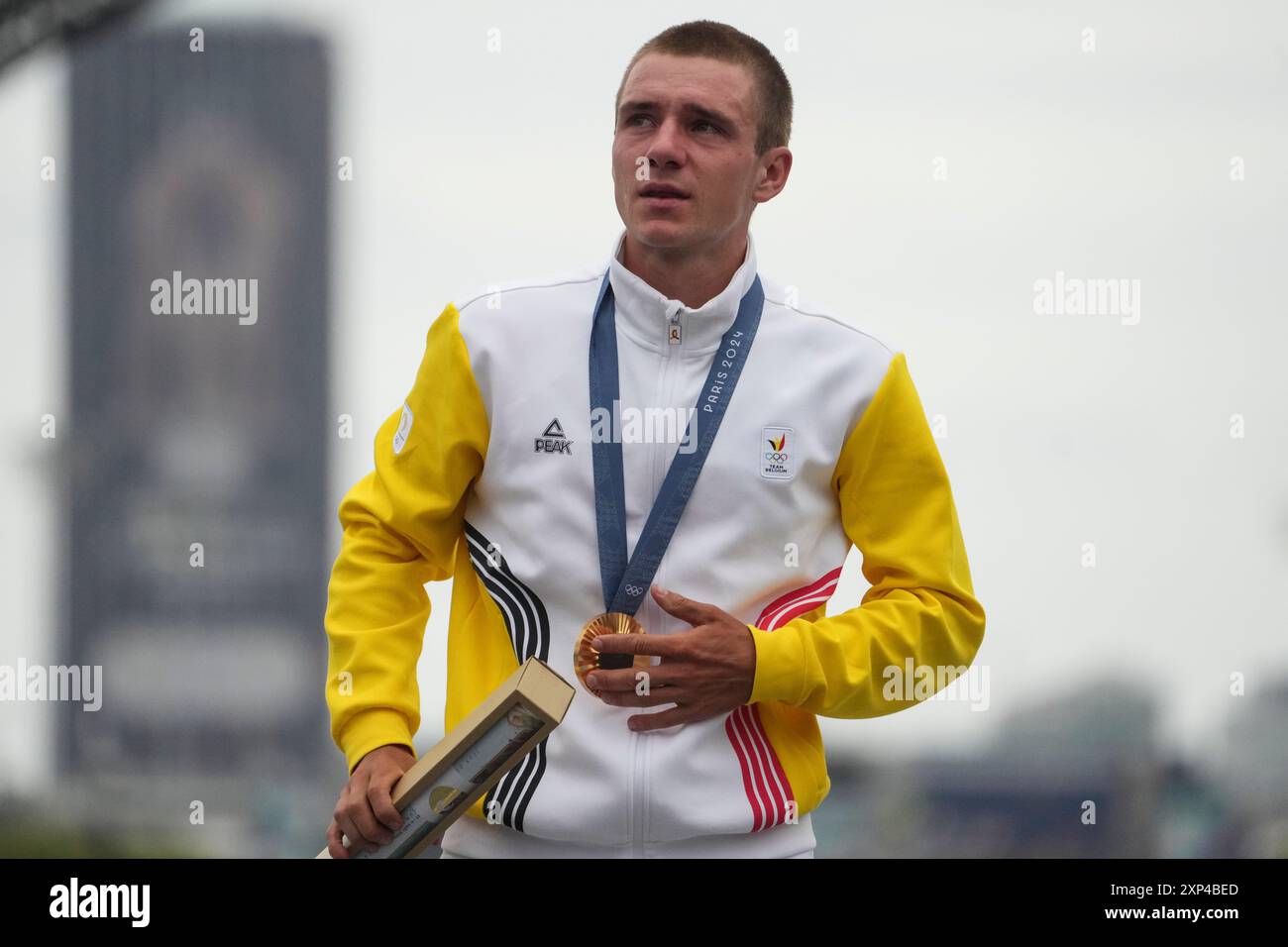 Remco Evenepoel, of Belgium, poses with the gold medal of the men's ...