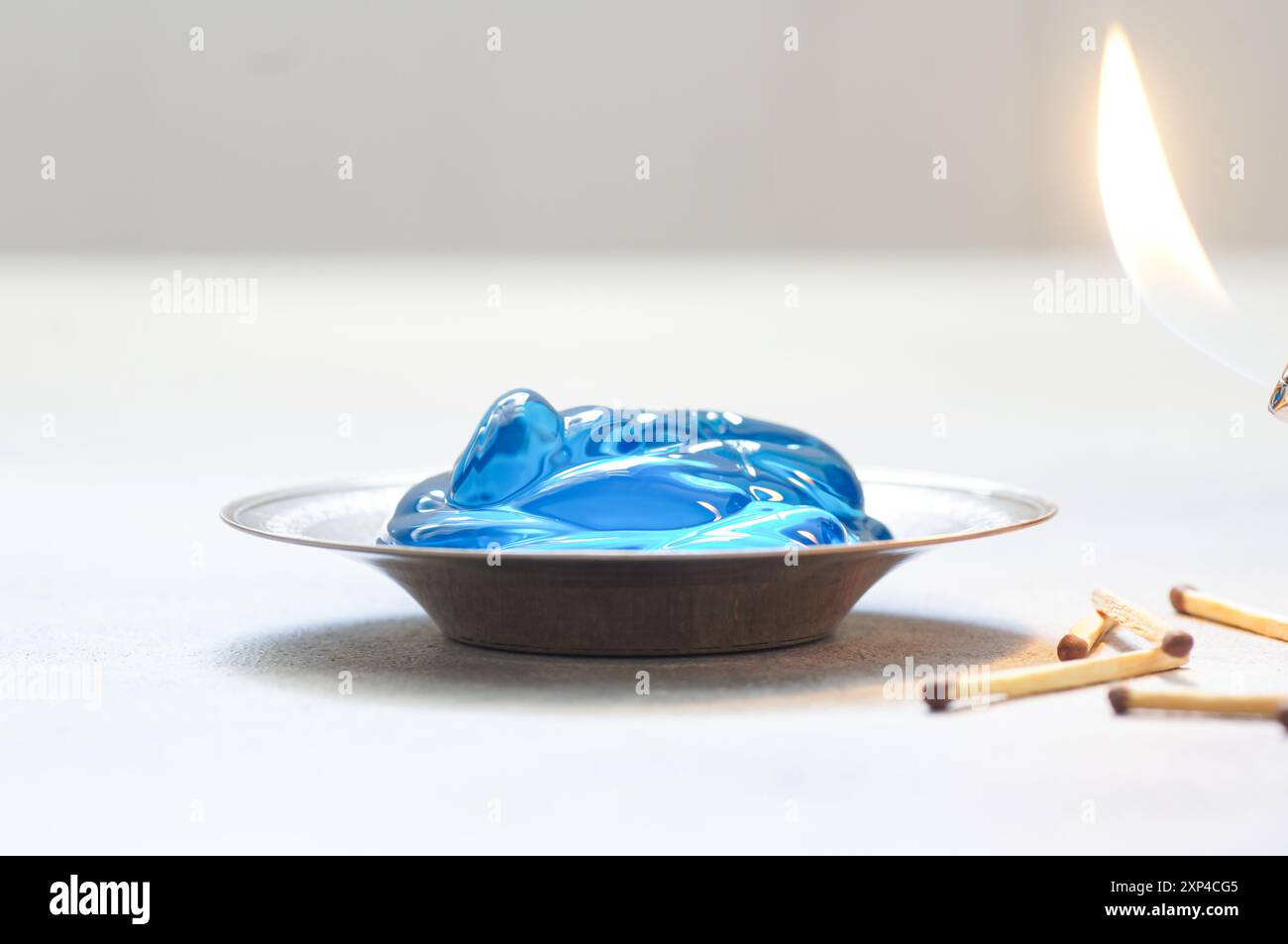 Chafing fuel gel poured into metal dish with matchsticks, blue chafer ...