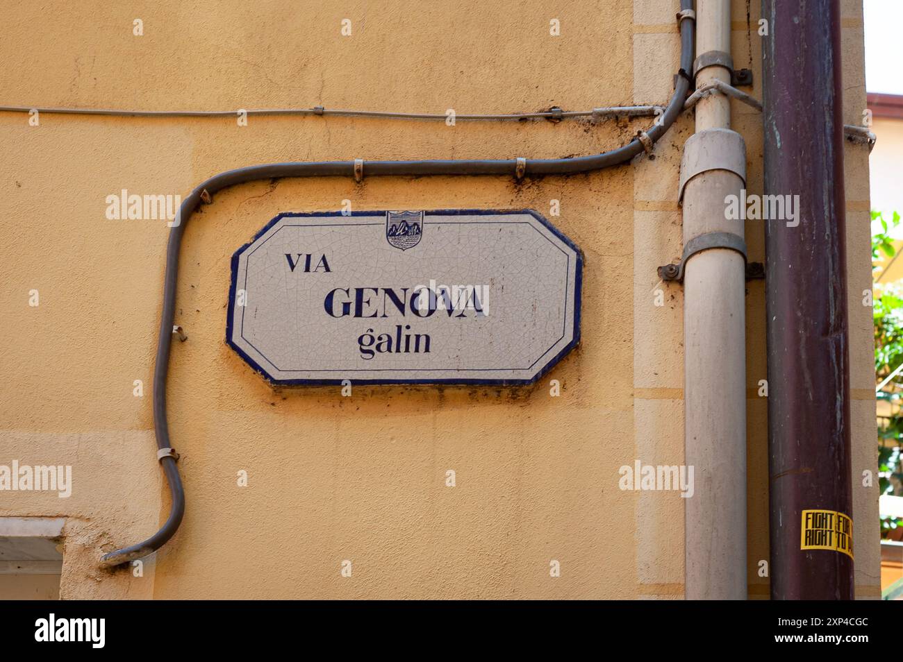 Decorative street sign 'Via Genova' on a wall in a street in a historic ...