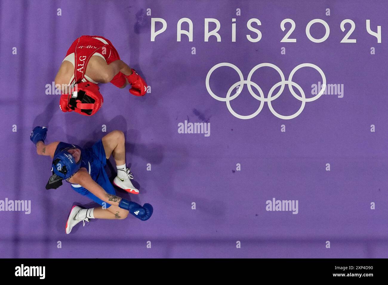 Hungary's Anna Hamori, in blue, falls to the mat against Algeria's ...