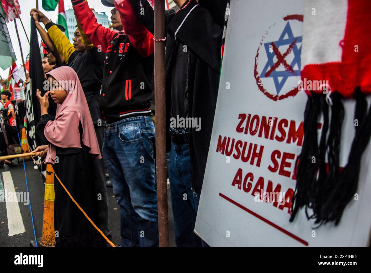 A poster showing the crossed out star icon on the Israeli flag is seen ...