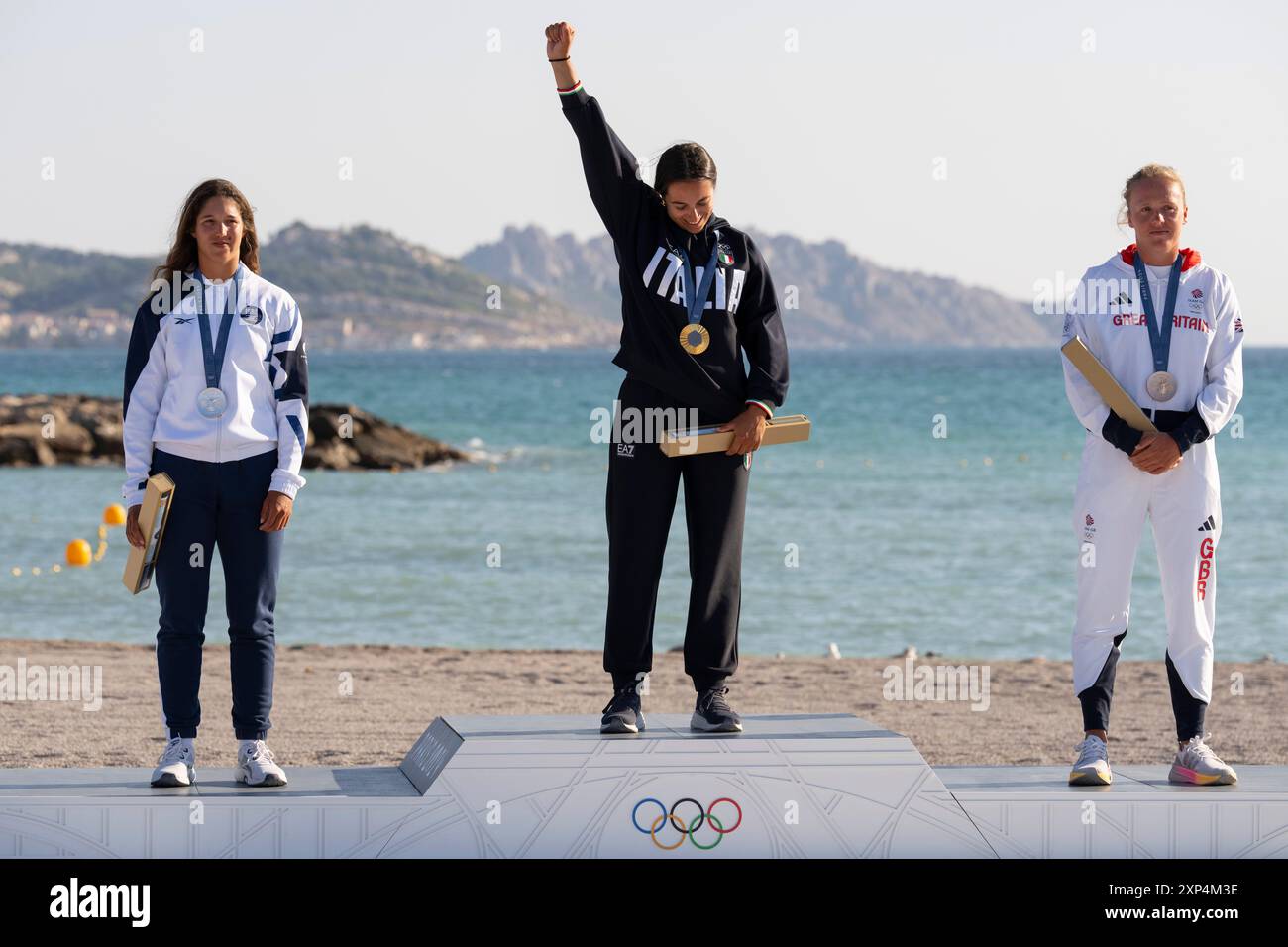 Marta Maggetti of Italy, center, celebrates winning the women's iQFOiL ...