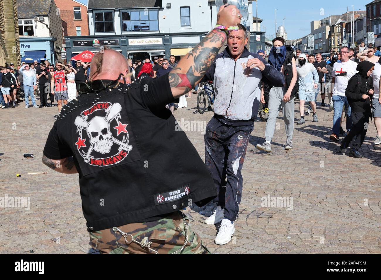 A fight breaks out between anti-fascists (back to camera) and other ...