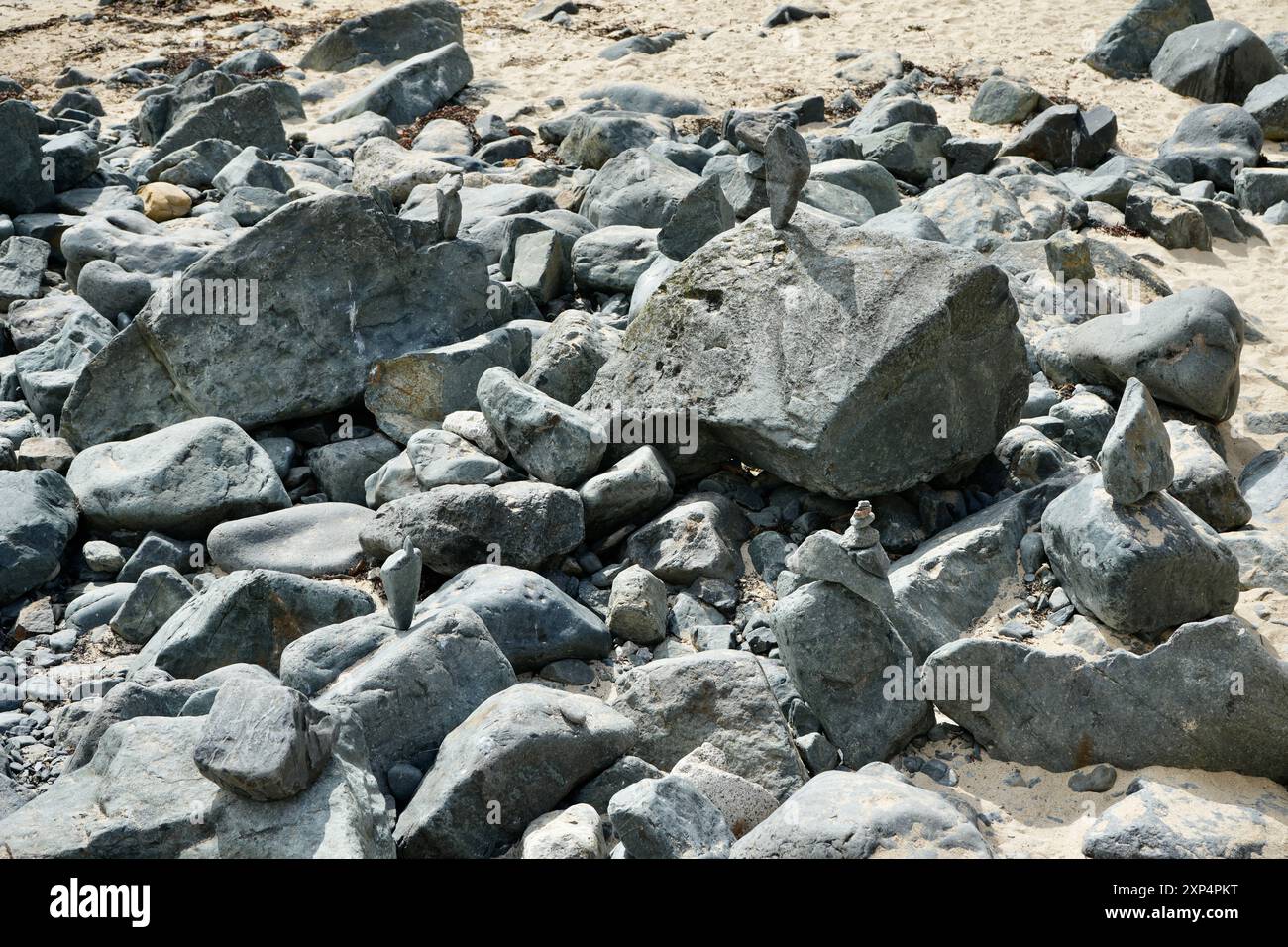 Balanced stones on rocks on a Cornish beach Stock Photo - Alamy
