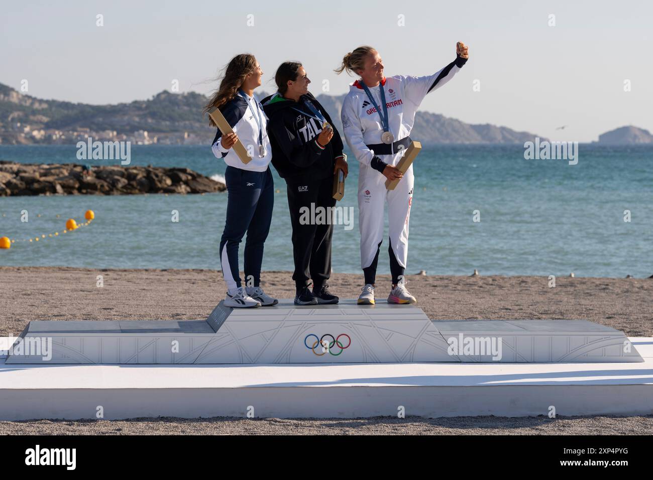 Marta Maggetti of Italy, center, winner of the women's iQFOiL ...