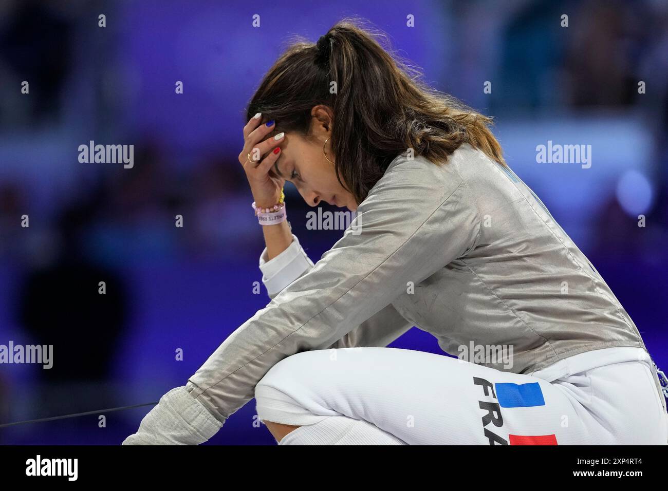 France's fencers Sara Balzer reacts after loosing the women's team ...