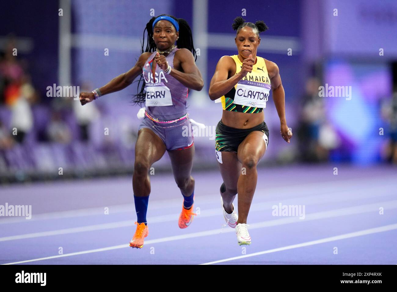 Tia Clayton, of Jamaica, wins a women's 100-meter semifinal ahead ...