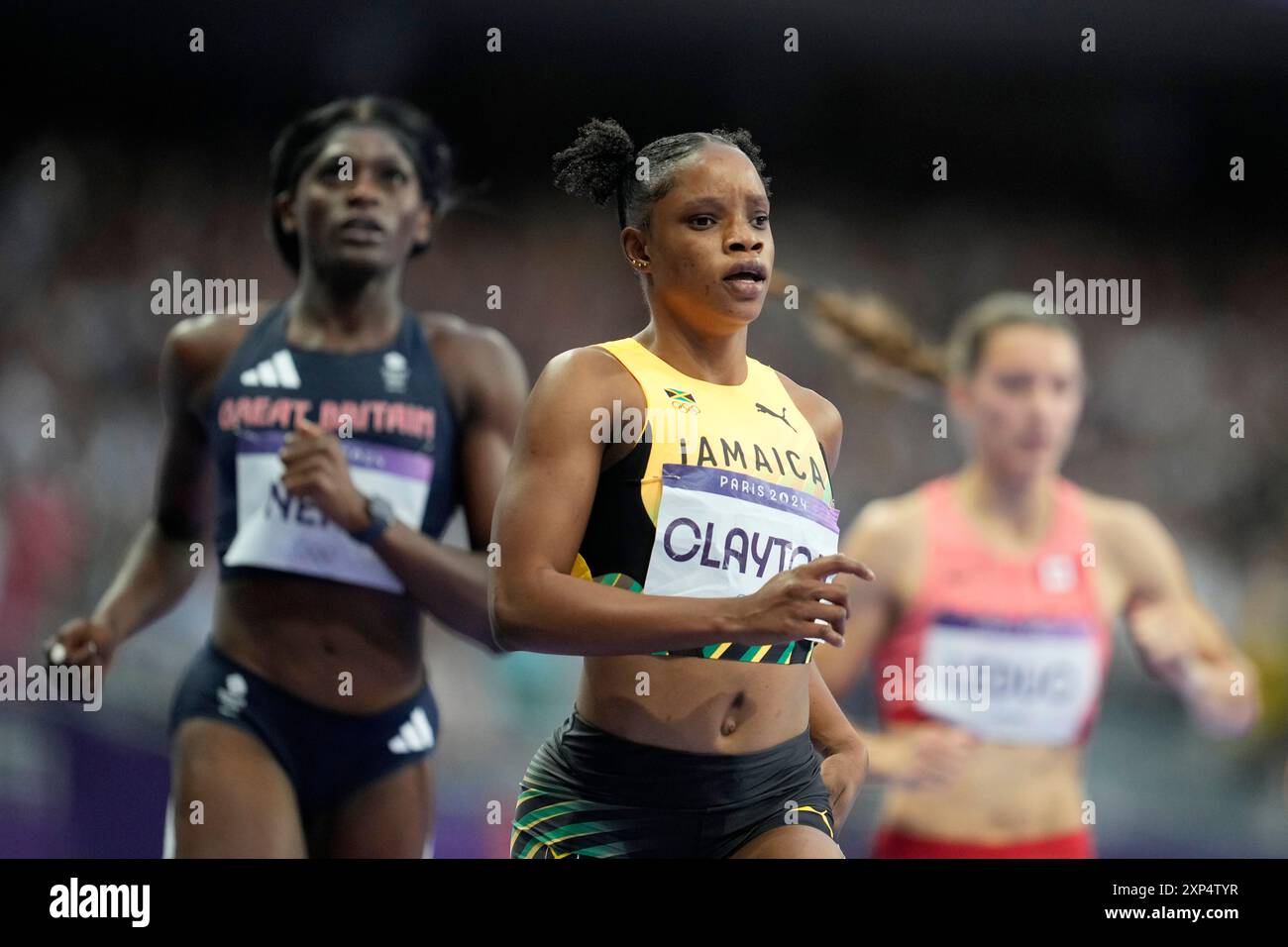 Tia Clayton, of Jamaica, and Daryll Neita, of Britain, left, cross the ...